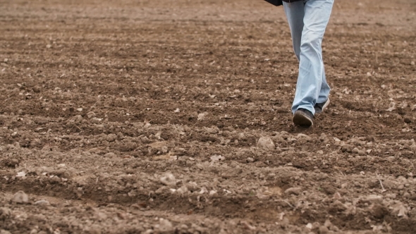 Farmer Walking On Farm Land, Planning New Seeding Season, Stock Footage
