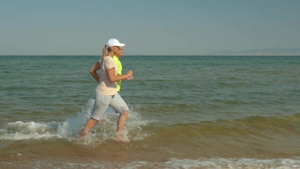 Young Couple Running In Shallow Sea Water, Stock Footage | VideoHive