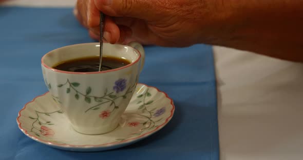 Close-up of hand stirring tea, Stock Footage | VideoHive