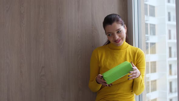 Girl at Home Fiddling with Gifts, Stock Footage | VideoHive