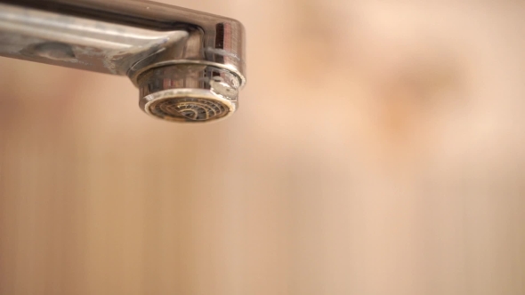 Chrome Shiny Faucet With Running Water Slows To a Drip, Stock Footage