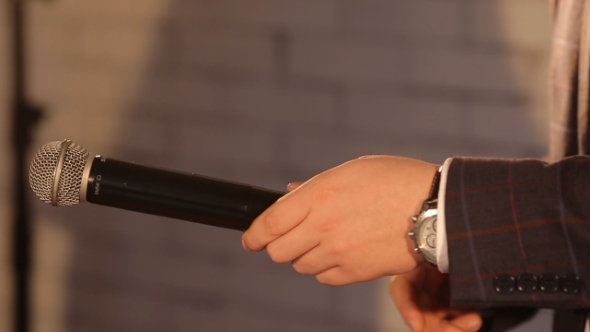 Man Throws The Microphone From Hand To Hand, Stock Footage | VideoHive