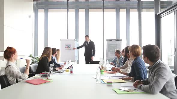 Handsome Director Pointing At Flipchart During A Meeting 2, Stock Footage