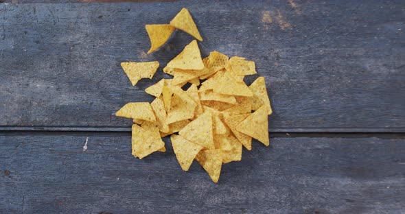 Close up view of nachos falling on wooden tray with copy space on ...