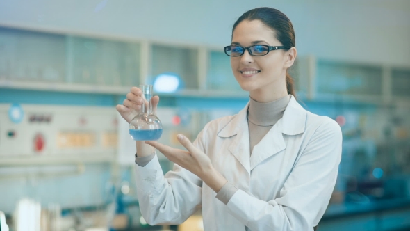 Smiling Woman In a Laboratory Holding Flask , Stock Footage | VideoHive