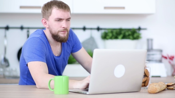 Man Is Working With a Laptop And Eating Apple, Stock Footage | VideoHive
