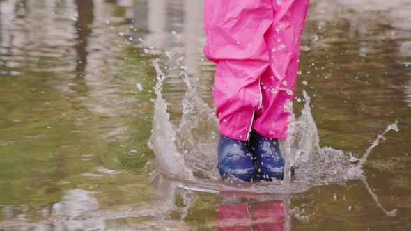 Fun Spring - Girl Jumping In a Puddle, Stock Footage | VideoHive