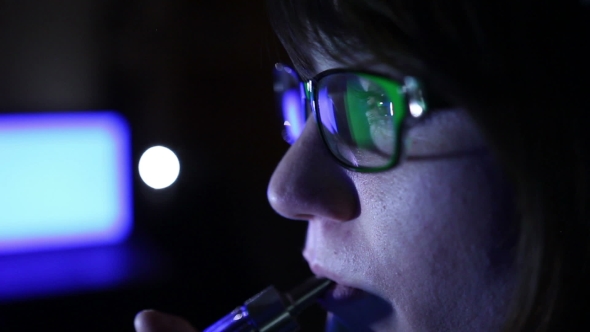 Hacker Girl Works At The Computer And Smoking Electronic Cigarette ...