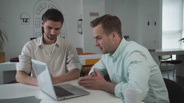 Two Men Looking at the Computer Discuss Business Project, Stock Footage