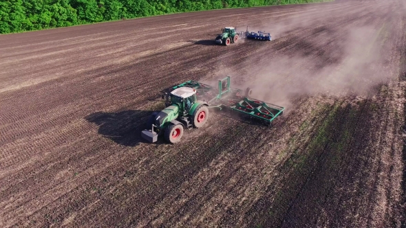 Two Tractor Ride Through The Field, Stock Footage | VideoHive