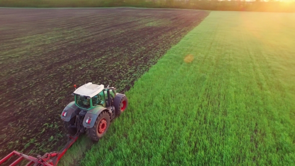 Tractor Working In a Field At Sunset. View From Above, Stock Footage