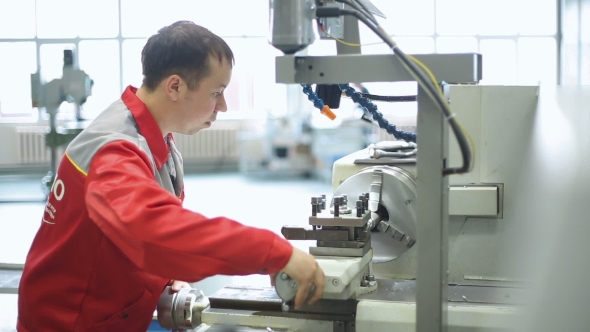 Metalworking On a Lathe In a Factory. Worker At a Machine, Stock Footage
