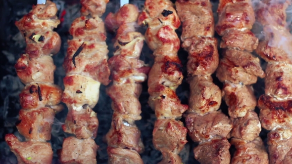 Grilling Food On Mangal. Rotate Skewers With Roasted Meat. Prepared ...