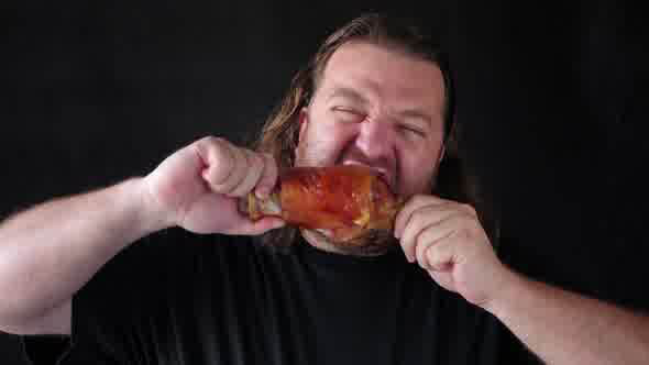 Man Biting With Relish A Piece Of Pork Knuckle, Stock Footage | VideoHive