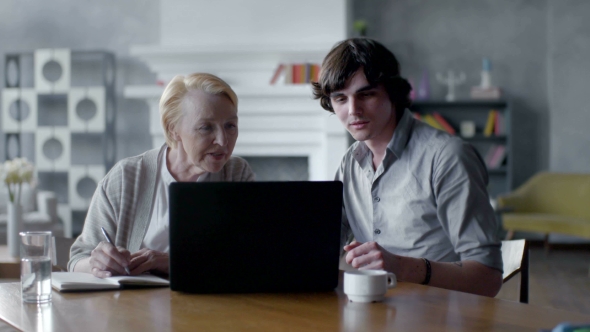 Grandson Teaching Grandmother How to Use a Laptop PC, Stock Footage