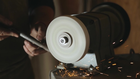 A Blacksmith Sharpening a Workpiece On a Grinding Lap, Stock Footage