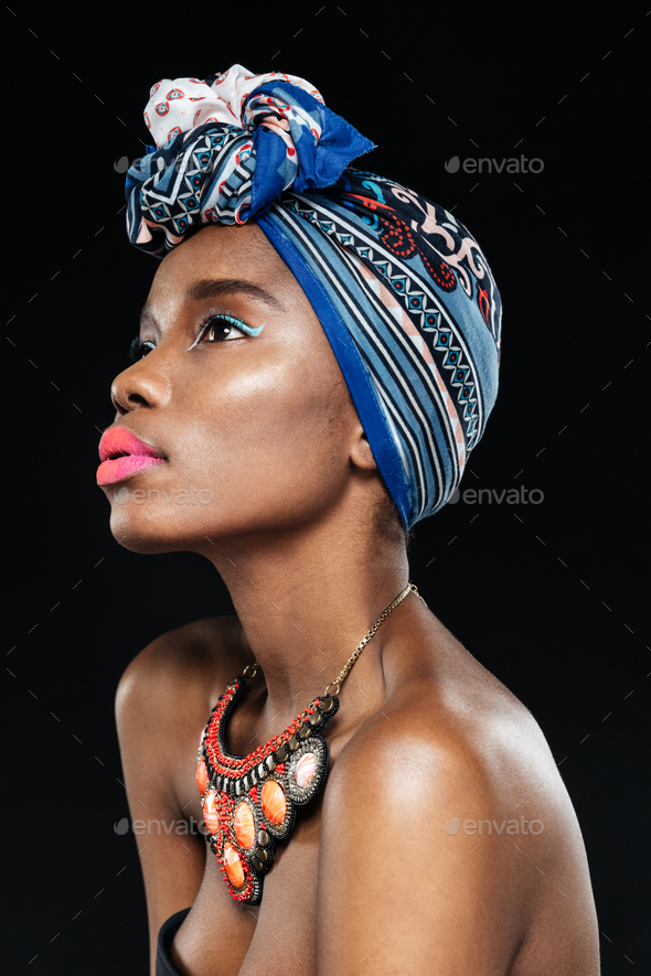 Side view of young african woman on black background Stock Photo by ...