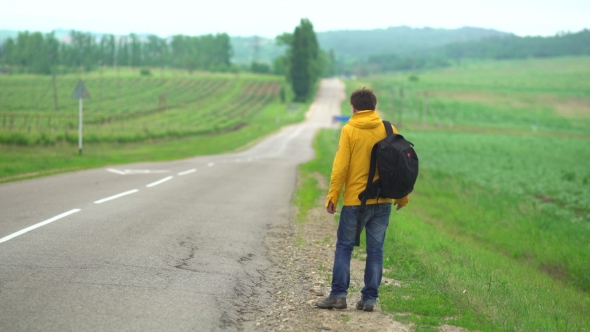 Man Hitchhiking In The Countryside, He Walk On An Empty Road Without ...