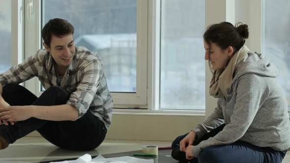 Two Friends Sit Near Big Window And Discuss Plan Of Building, Stock Footage