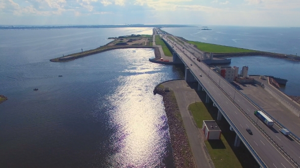 Aerial view of road bridge over water, which is at the dam, Stock Footage
