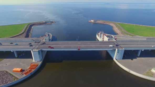 Aerial view of road bridge over water, which is at the dam, Stock Footage