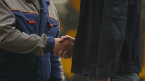 Two Workers Shake Hands At The Factory, Stock Footage | VideoHive