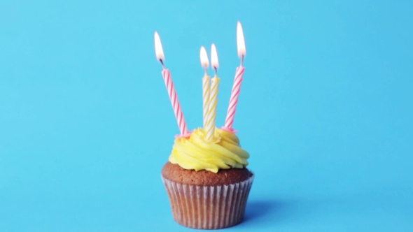 Birthday Cupcake With Four Burning Candles, Stock Footage | VideoHive