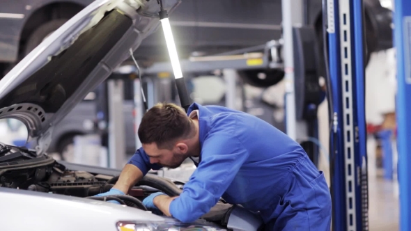 Mechanic Man With Lamp Repairing Car At Workshop 43, Stock Footage