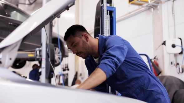 Mechanic Man With Lamp Repairing Car At Workshop 20, Stock Footage
