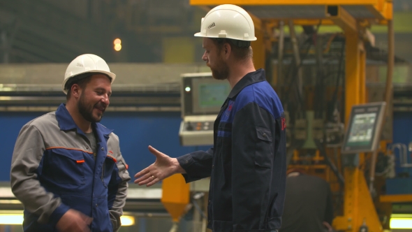 Two Engineers Smile, Laugh And Shake Hands In Heavy Industry Factory ...