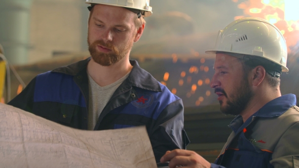 Portrait Of Two Serious Engineers Explore Project In Heavy Industry ...