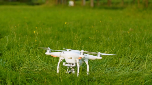 RC quadcopter with camera flies with green lawn, Stock Footage | VideoHive