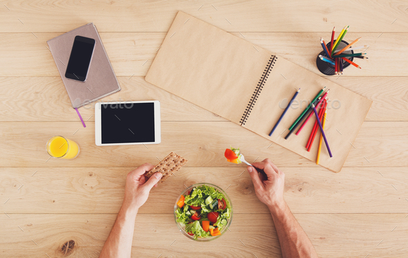Healthy business lunch top view at table. Stock Photo by Prostock-studio