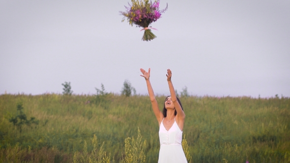 Young Woman Standing On Green Field Throwing a Flower Bunch, Stock Footage