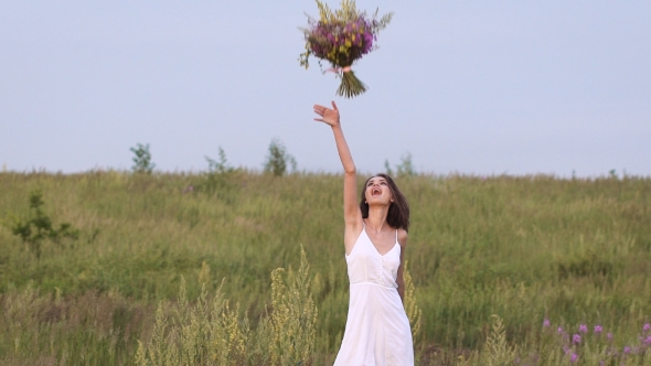 Young Woman Standing On Green Field Throwing a Flower Bunch, Stock Footage