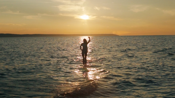 Girl Dancing In The Sea In The Sunset, Stock Footage | VideoHive