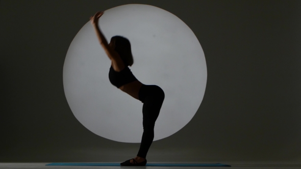 Gymnast Performs a Forward And Backward Tilt. Back Light. Silhouette ...