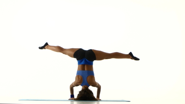 Gymnast Stands On Her Head And Changes The Pose Of Legs. White, Stock ...
