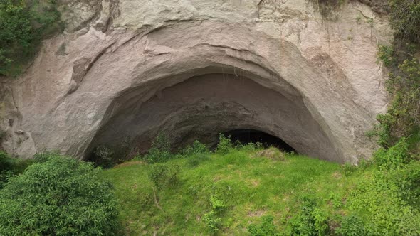 Starting at a large cave entrance shwoing the whole entrance and it's ...