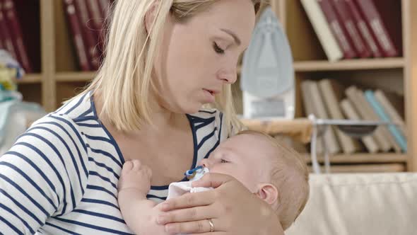 Young Mother Rocking Baby Son to Sleep, Stock Footage | VideoHive