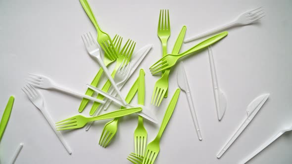 Lots Plastic Forks and Eating Utensils Are Falling on White Background ...