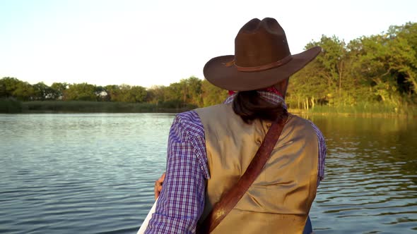 Cowboy in a Canoe Floats on the River, Stock Footage | VideoHive