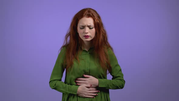 Woman Squeezing Belly with Hands Because of Abdominal Pain, Stock Footage