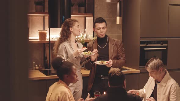 LGBTQ Friends Eating and Talking at Cozy Dinner Party, Stock Footage