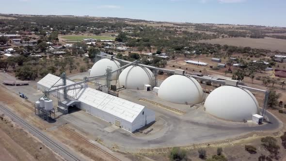 Four dome silos ready to store harvested grain - orbiting aerial view ...