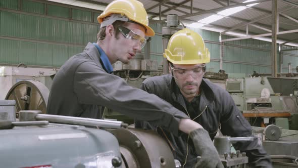 Engineer man training with foreman for apprentice using lathe ...