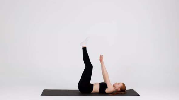 Athletic Young Female Making Pike Crunch Exercise On Fitness Mat In ...