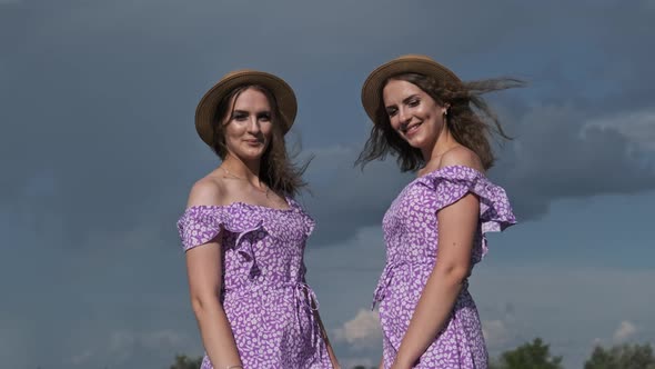 Portrait Two Young Twin Girls in Identical Dresses Looking in Camera in ...