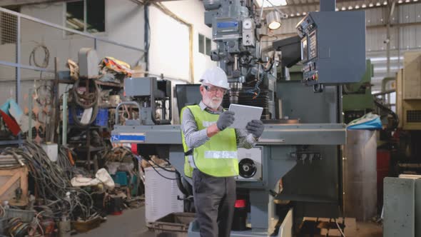 Senior factory worker man work in factory and express upset with the ...