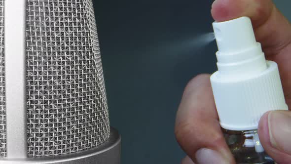 Macro Shot of Hand Spraying Sanitizer To a Microphone, Stock Footage